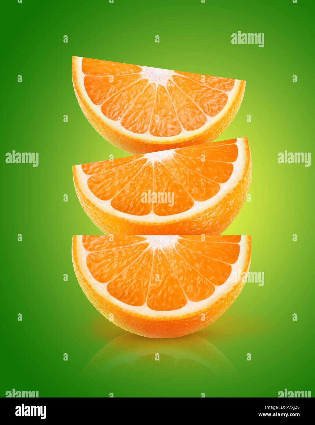 Three pieces of orange fruit on top of each other over green background ...