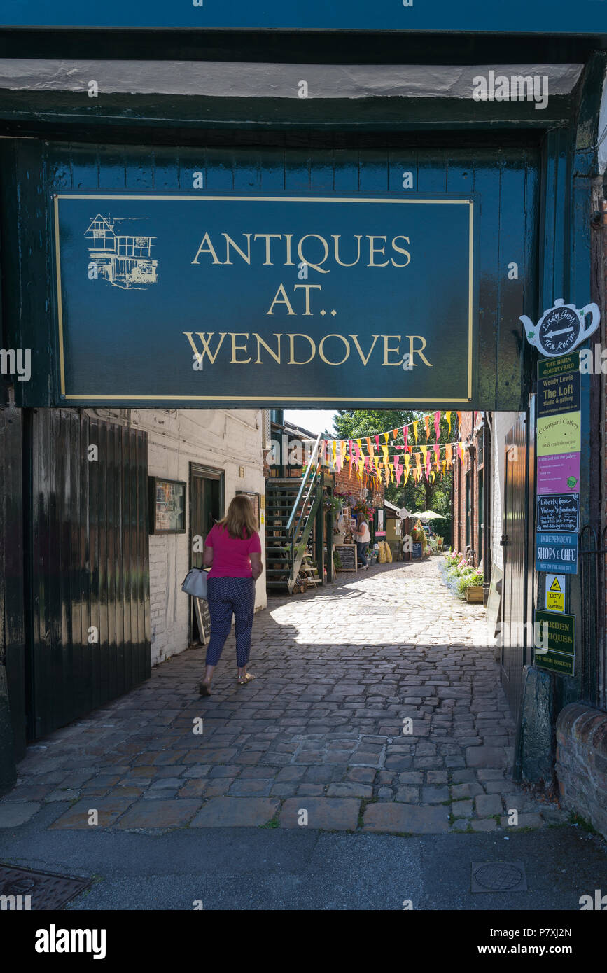 Woman walks towards the gift shops, gallery and Lady Grey Tea Room, in ...