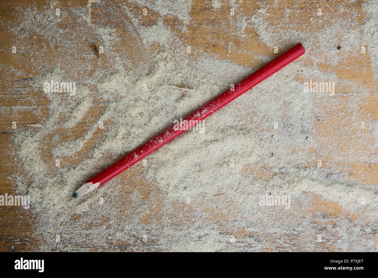 Used construction or industrial wooden red graphite pencil on wooden ...