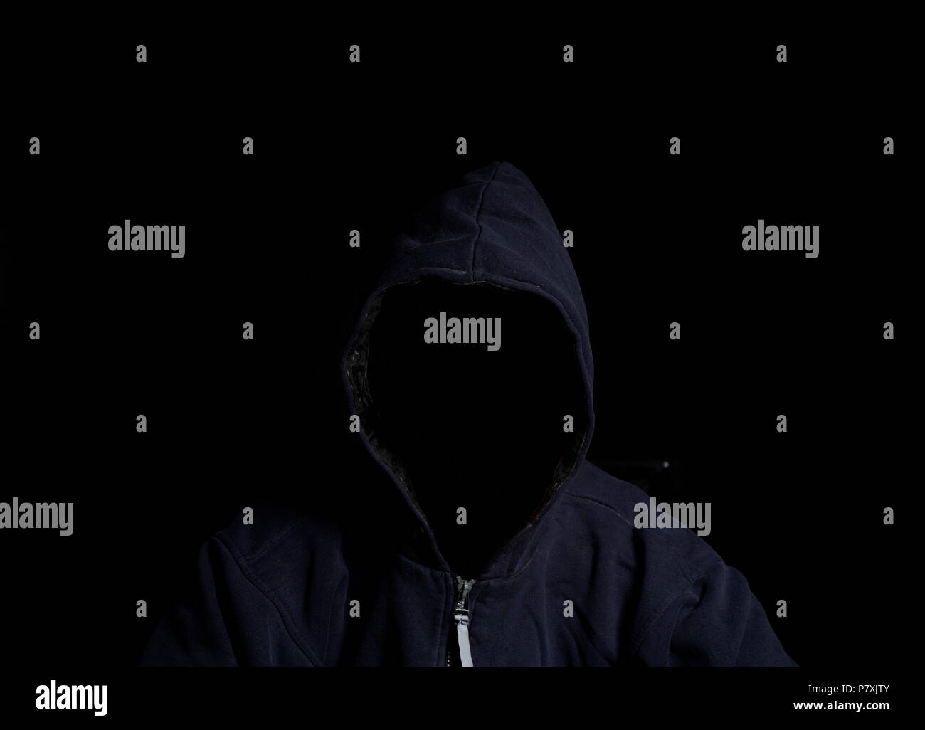 Anonymous criminal man in hood isolated on black background Stock Photo ...