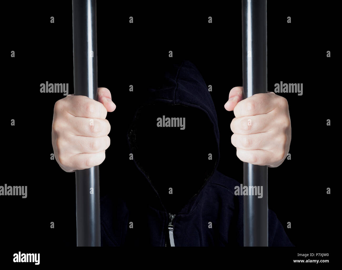 Anonymous criminal prisoner in hood holding prison bars isolated on ...