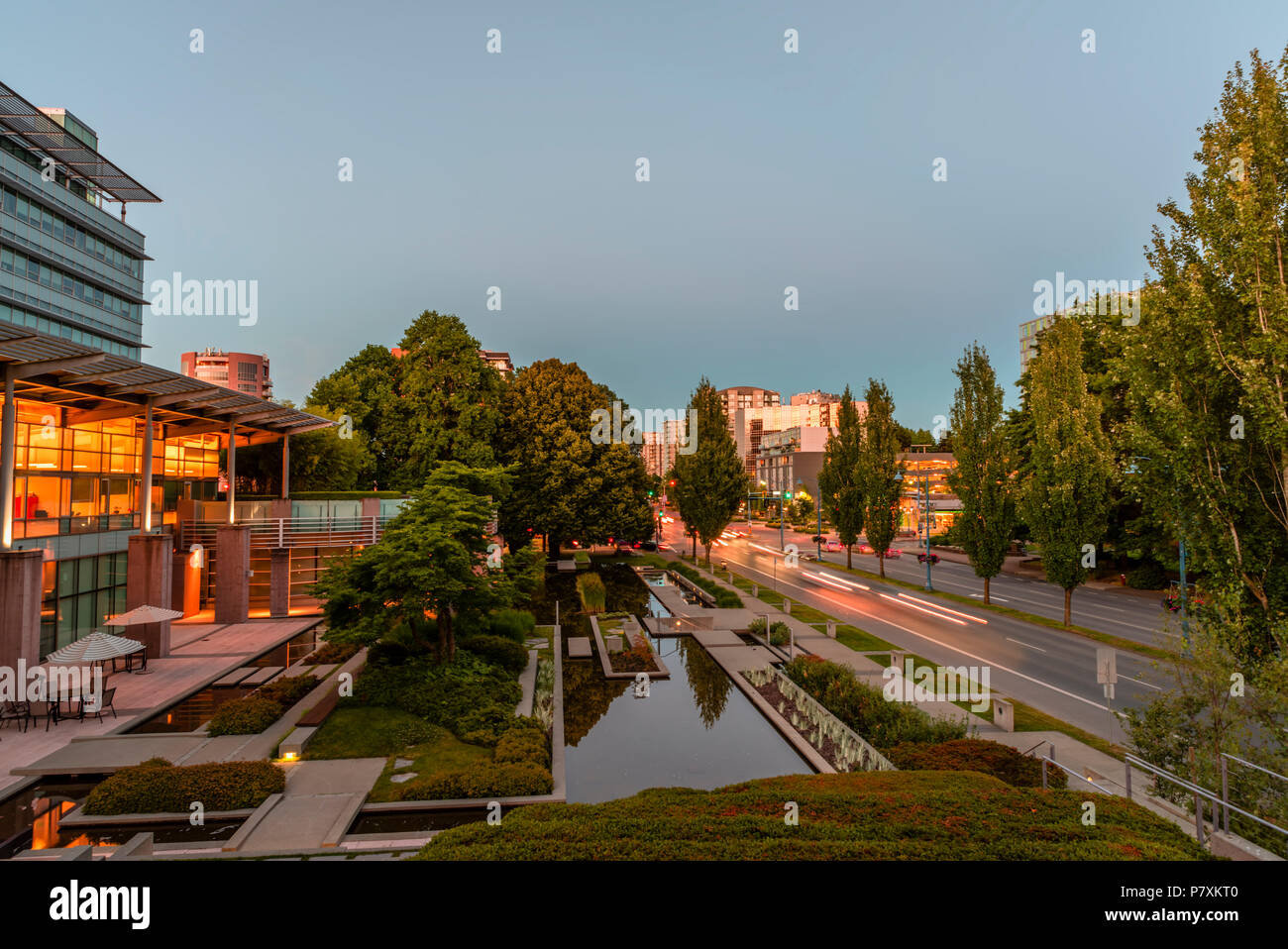 night street of a modern city, buildings with luminous windows, car ...
