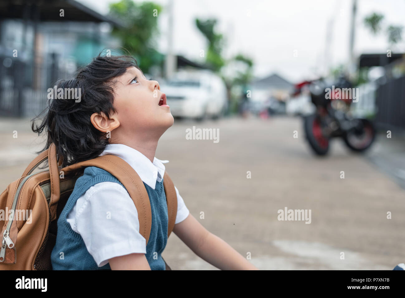 Little boy boring to go to school in the morning. Kids sitting on ...