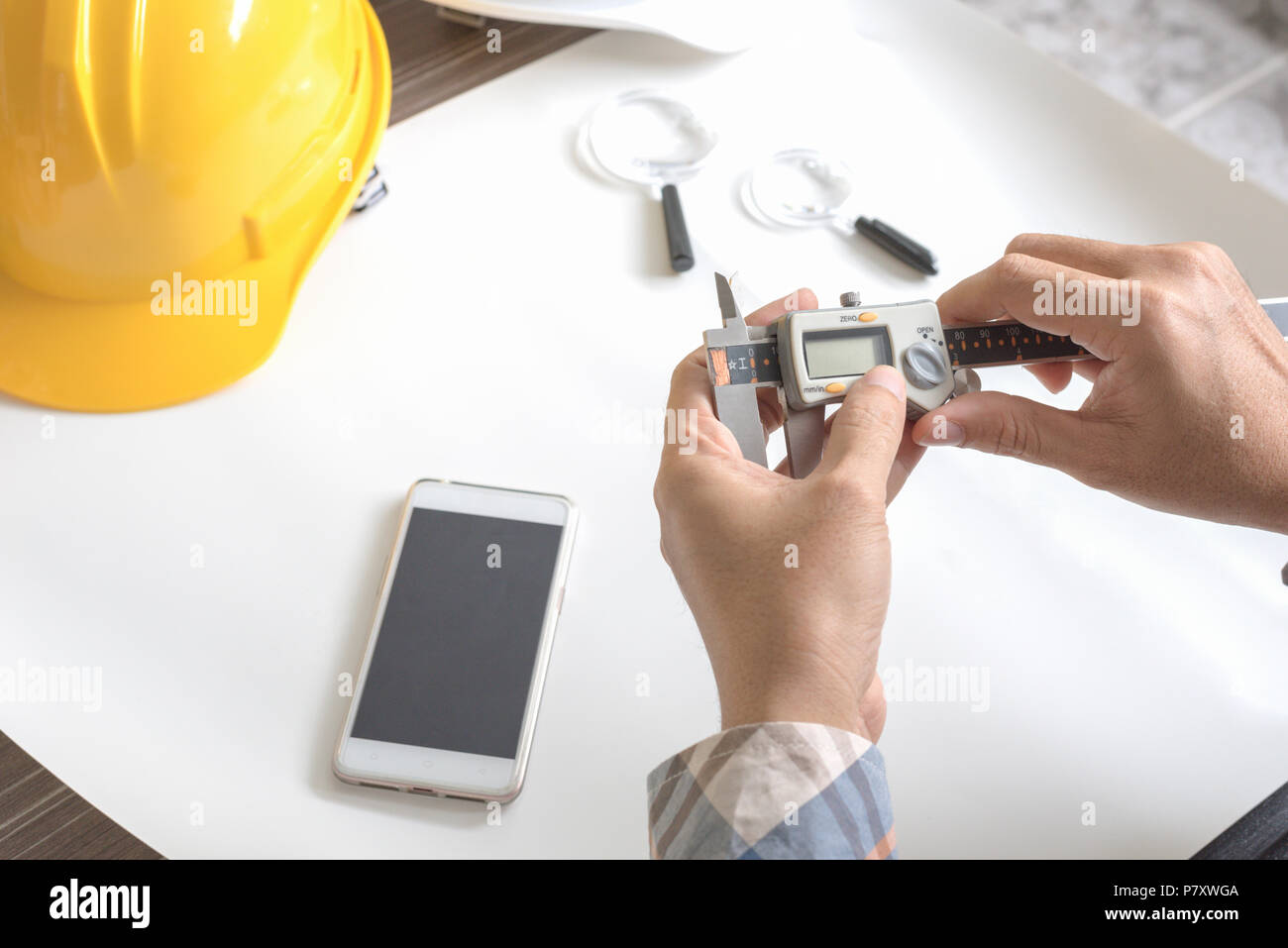 Construction engineer measuring with vernier caliper. Business and ...