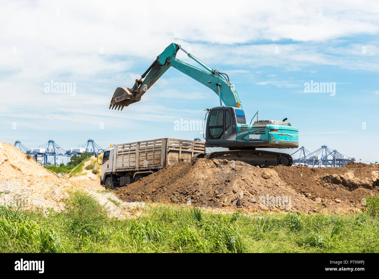Digger car load and transfer soil to truck on the hill, Technology ...