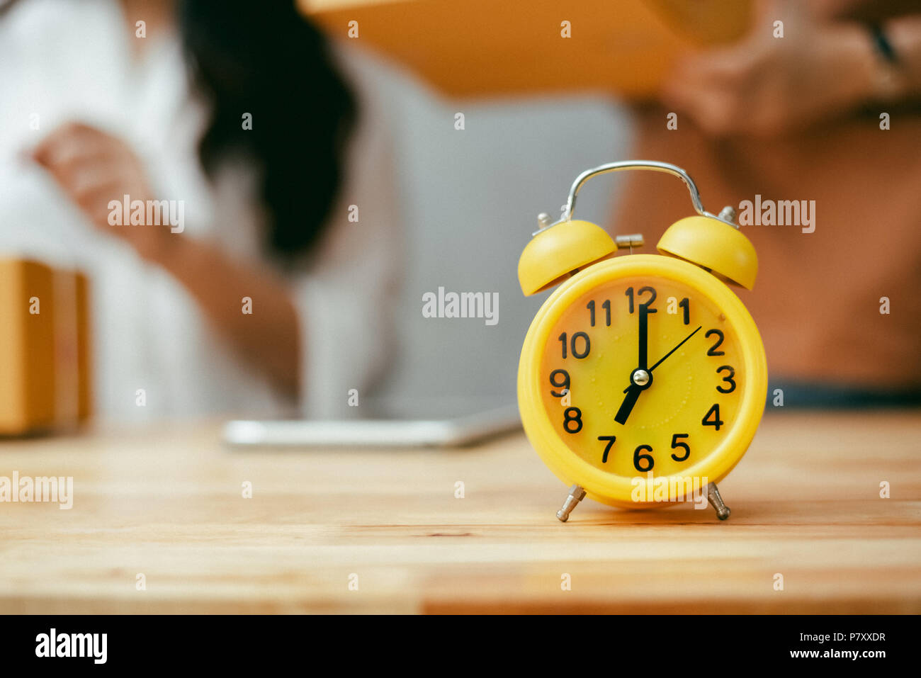 Woman checking clock office hi-res stock photography and images - Alamy