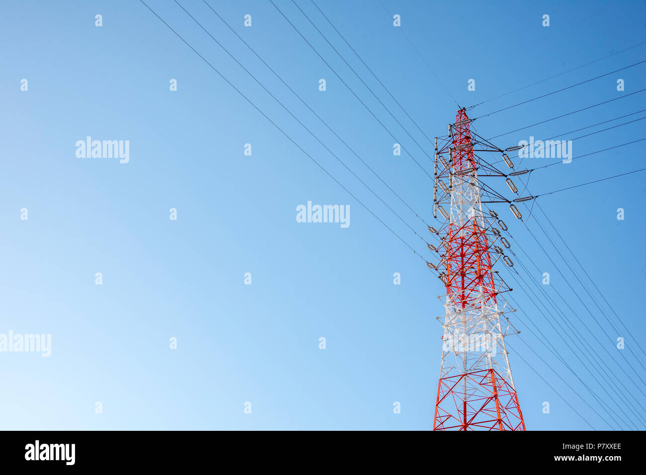 Red and white wired Electric cable Telecom post with blue sky ...