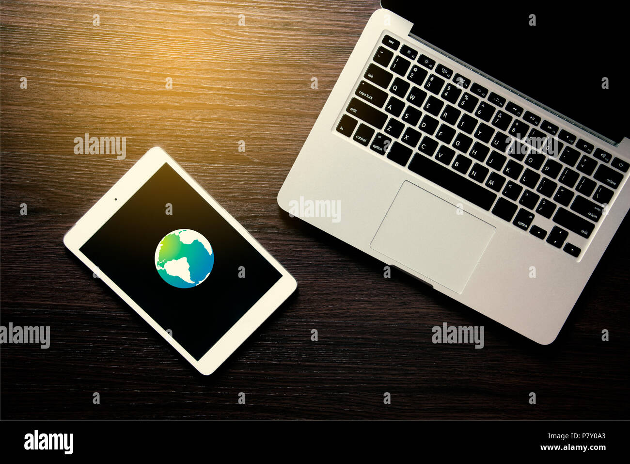 Internet communication globe in the device screen Stock Photo - Alamy