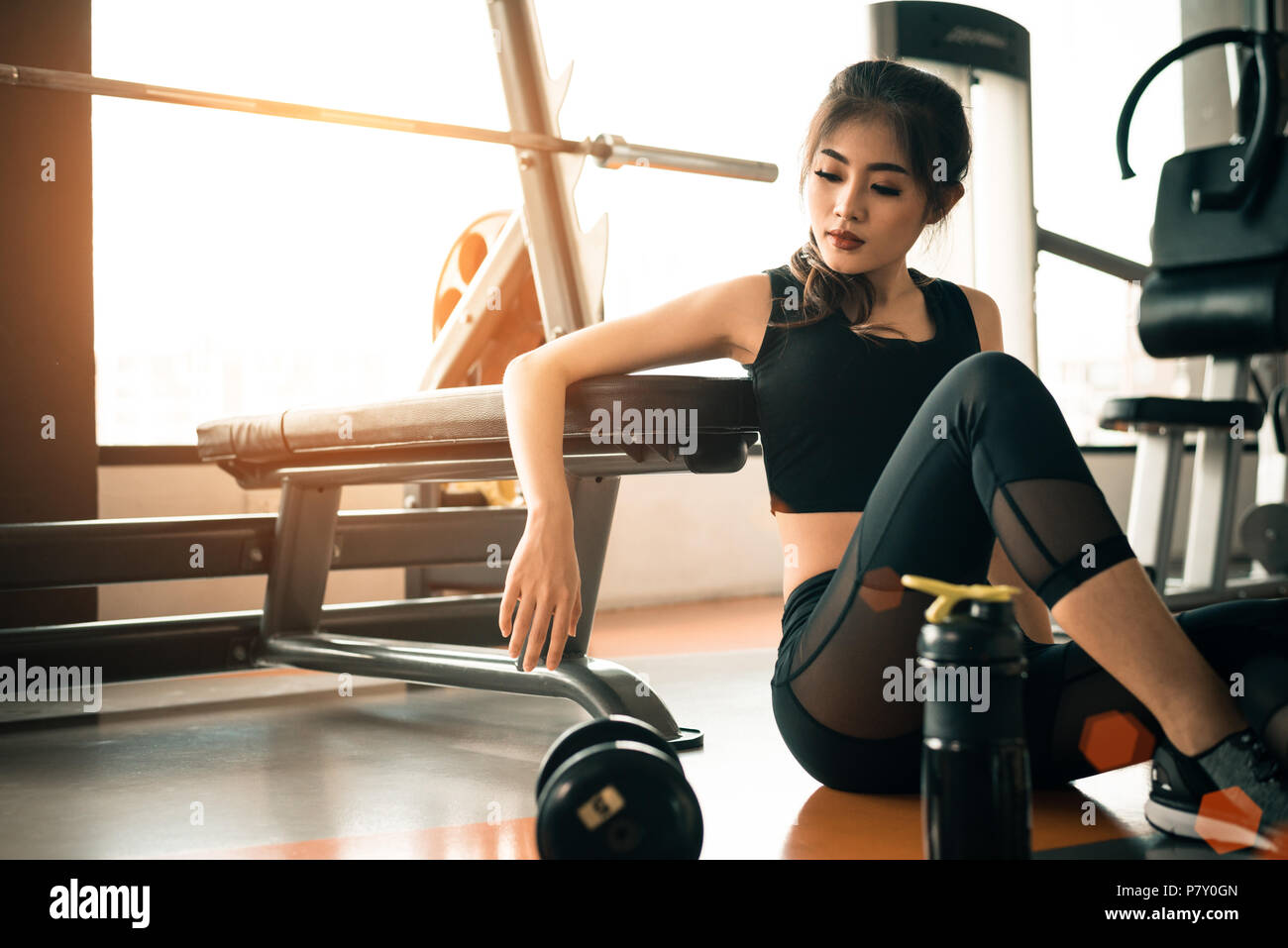 Asian young woman relaxing in fitness gym and sport club center with ...