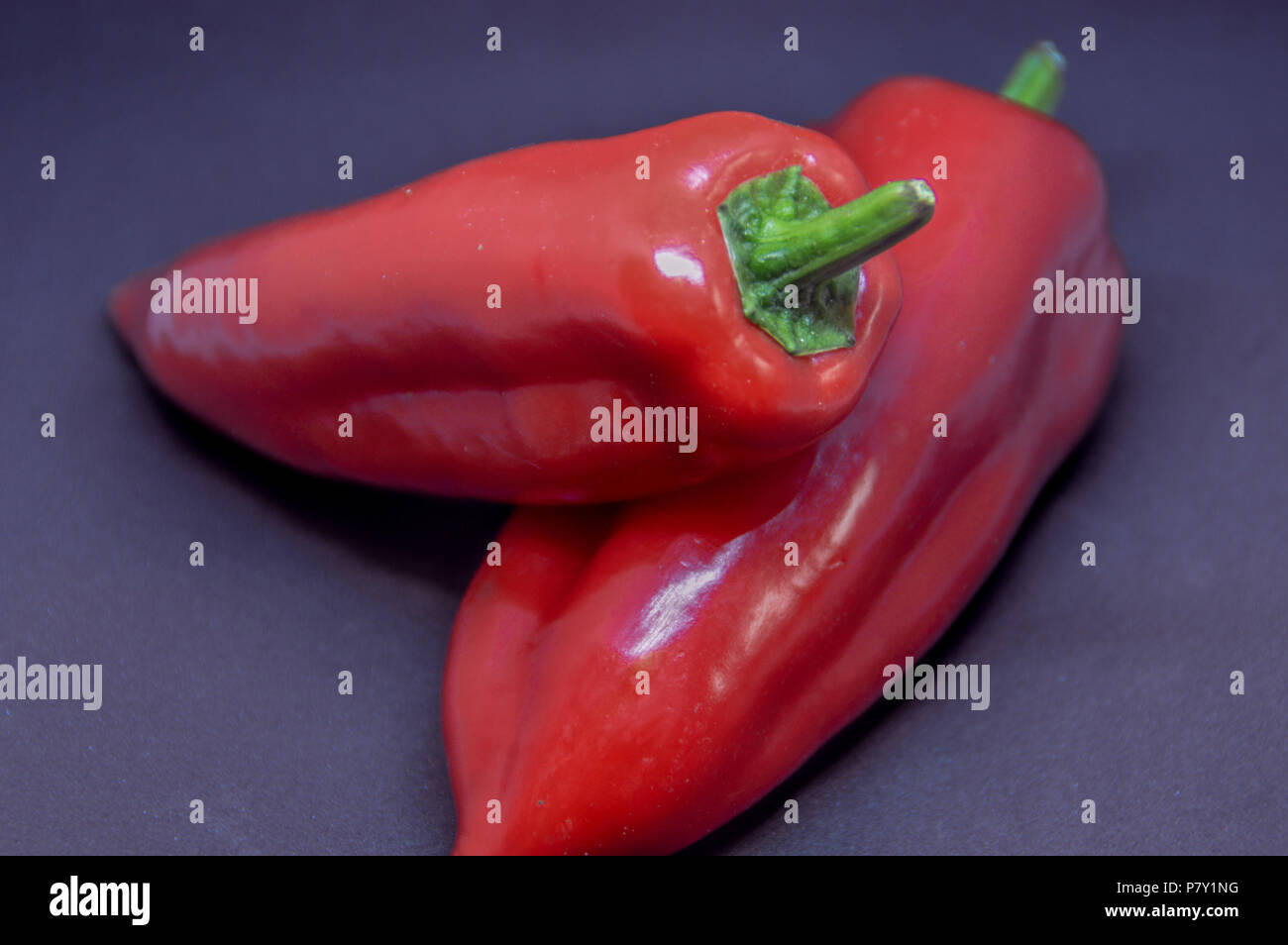 Low light photography of red bell peppers Stock Photo - Alamy