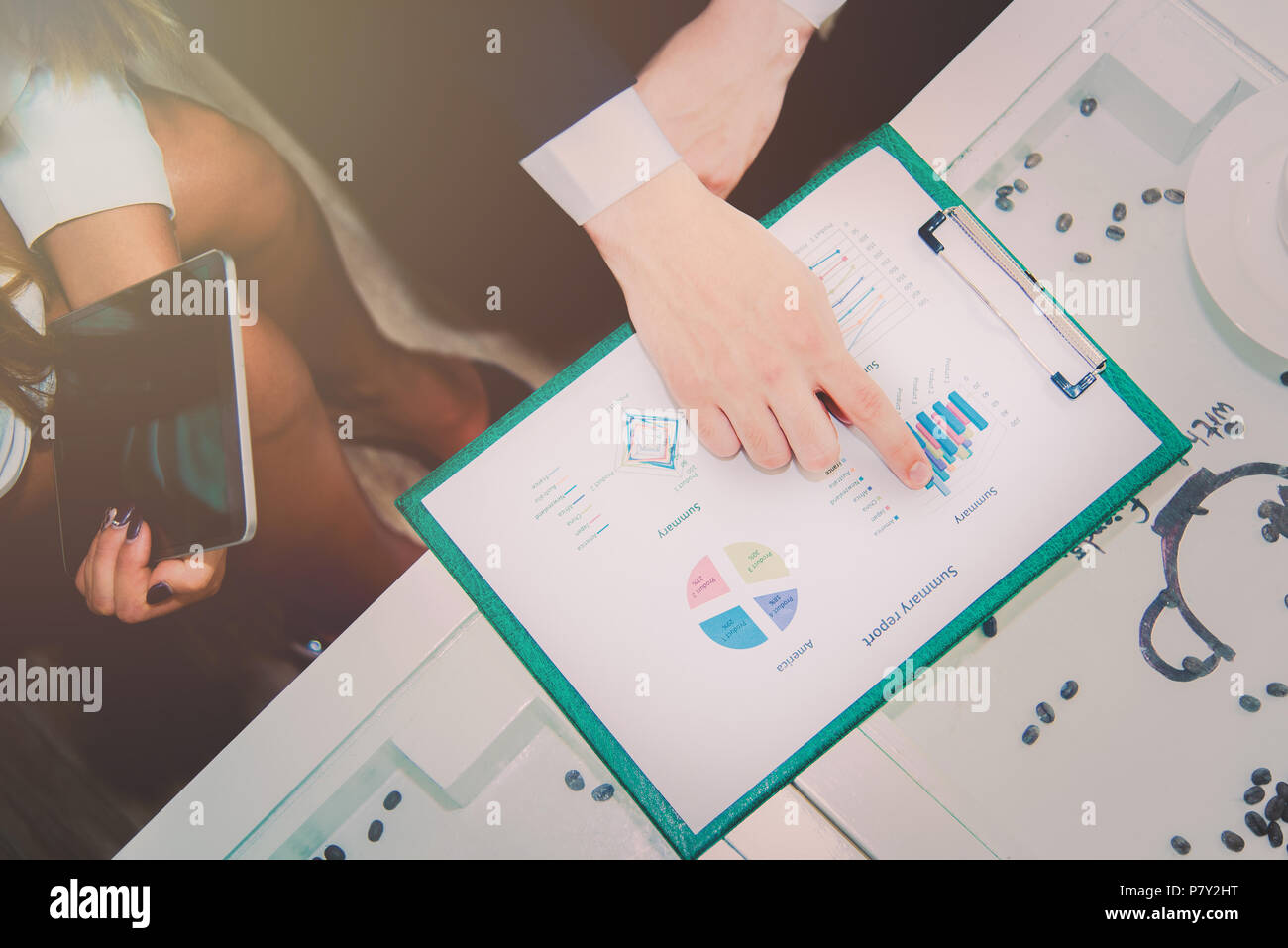 Business manager pointing to summary report and analyze graph plans ...