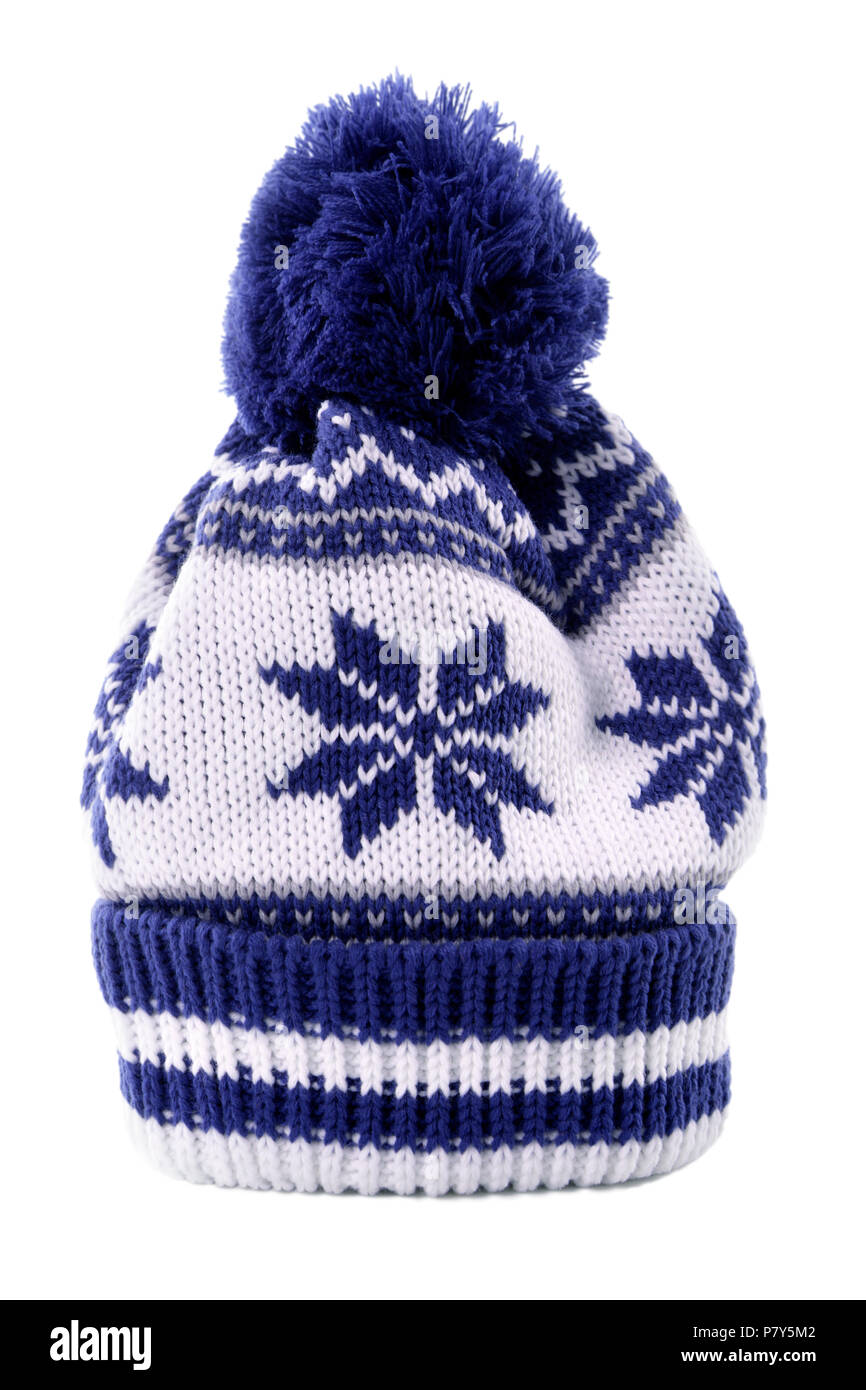 Blue bobble hat or knit hat with snowflake pattern isolated against a ...