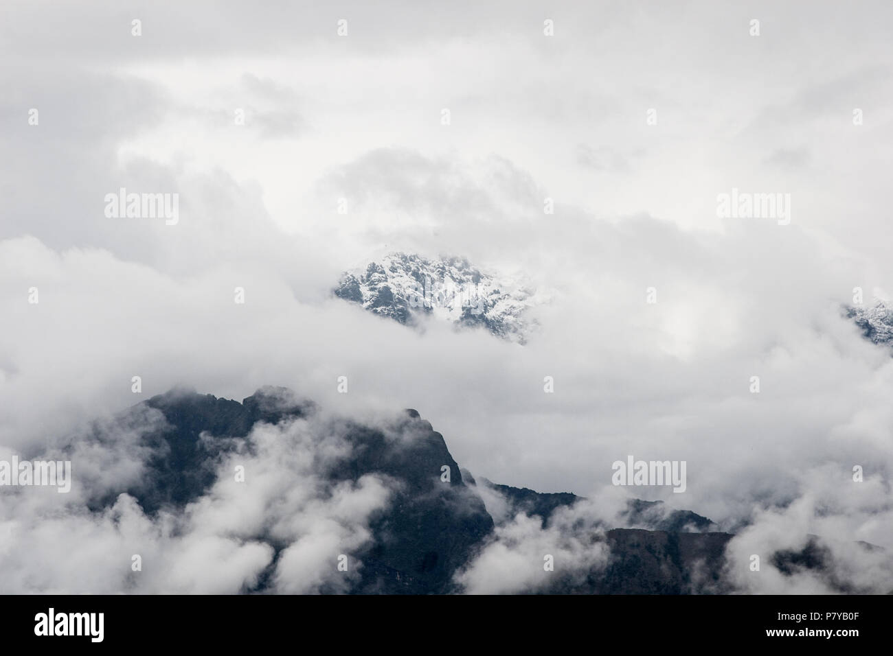 Intense fog and clouds covering the peak of a mountain on the Andes ...