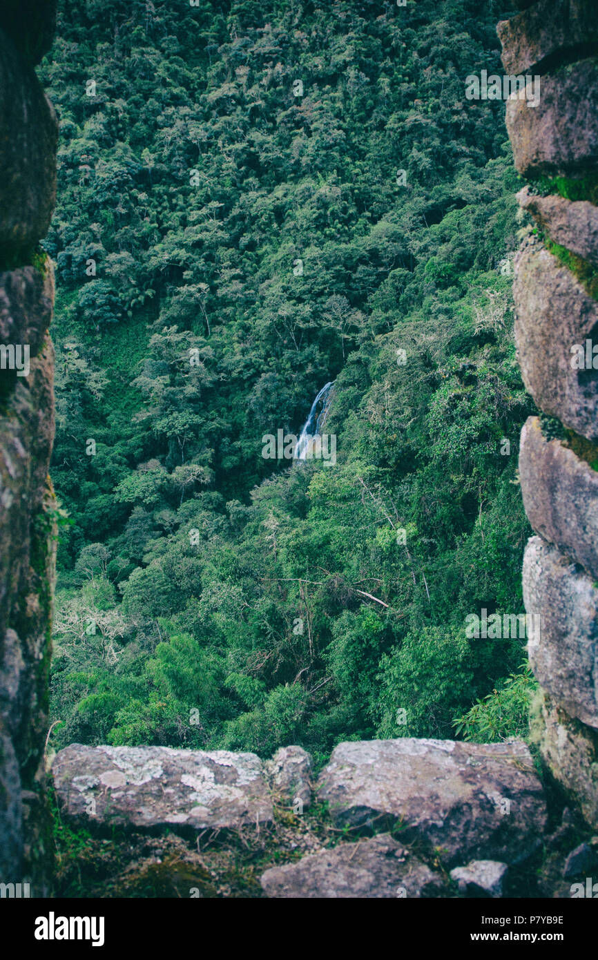 Ancient stone window view of the mountains with a waterfall Stock Photo ...