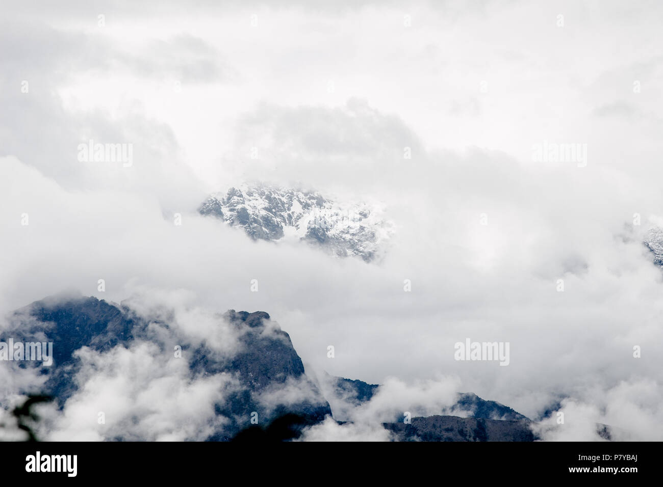 Intense fog and clouds covering the peak of a mountain on the Andes ...