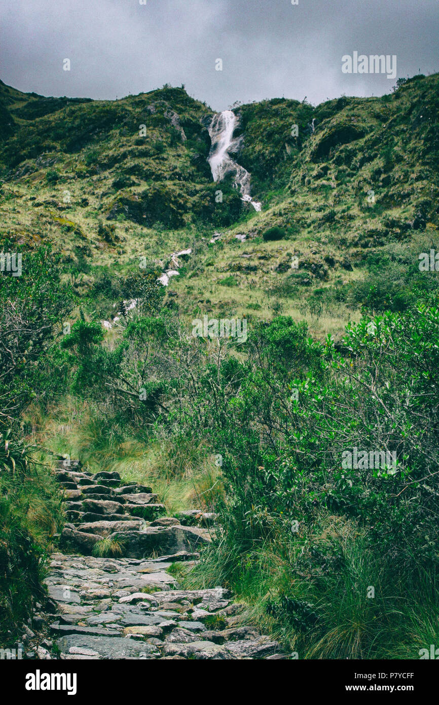 Waterfall on the stone paved path Inca Trail Stock Photo - Alamy