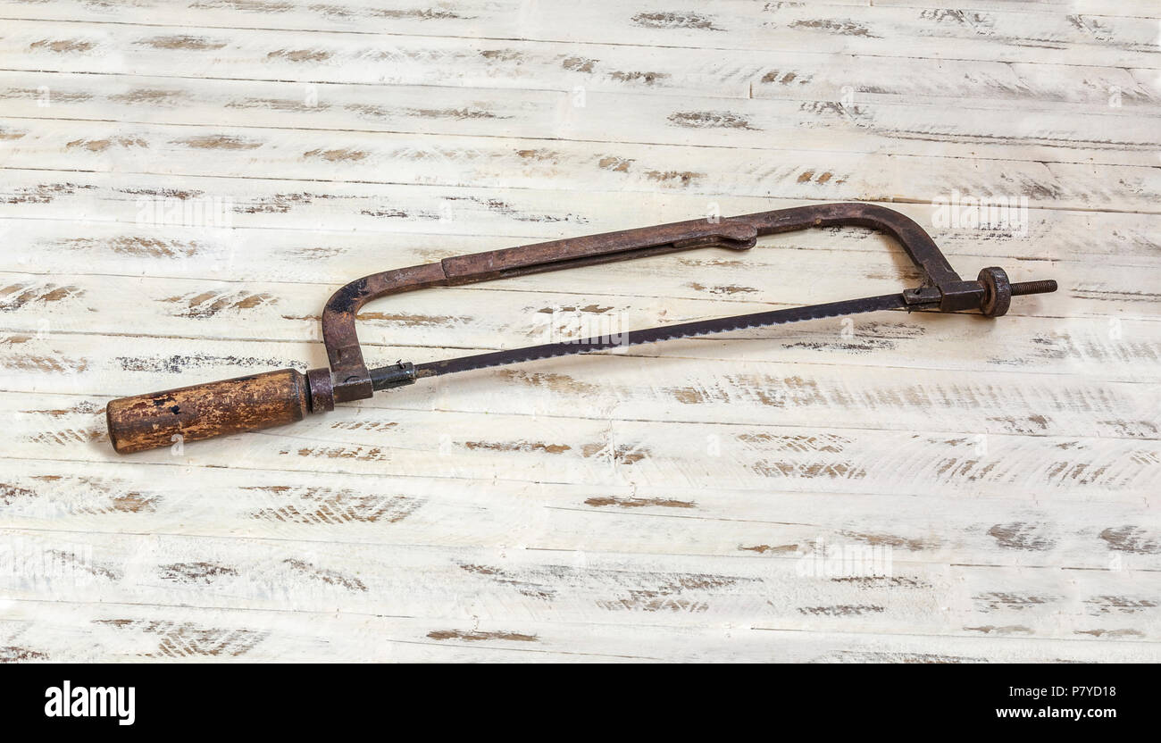 Hand carpentry tools. Hacksaw for metal on wooden pavement Stock Photo ...