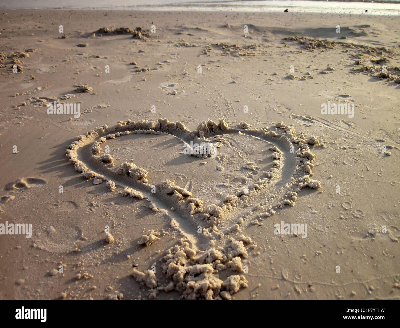 an image of heart shape drawing on the sand Stock Photo - Alamy