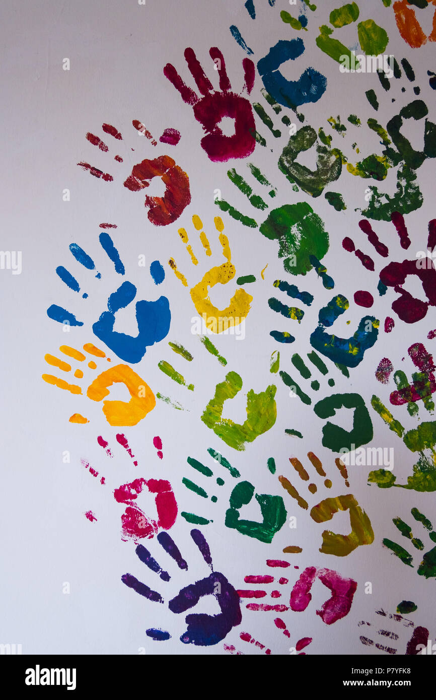 Colorful handprints on a white concrete wall Stock Photo - Alamy