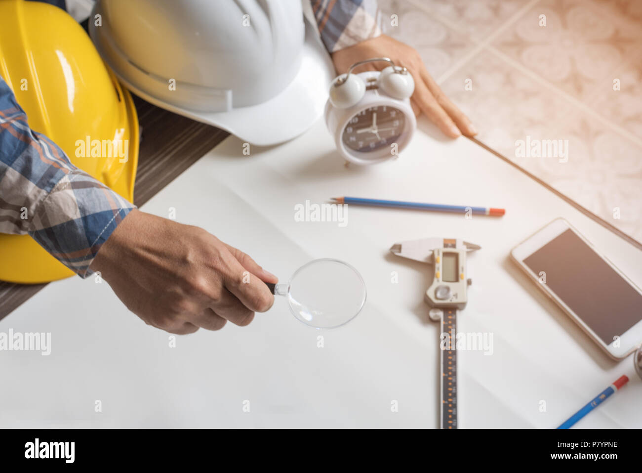 Engineer with magnify glass for looking blank paper for new project ...