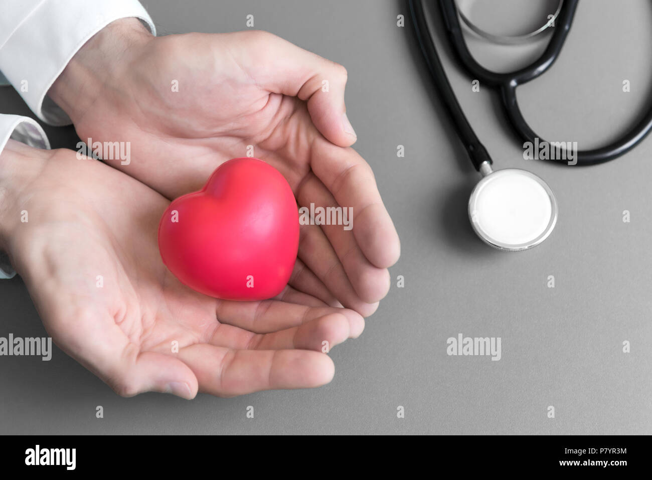 On the top view, Doctor give mini heart to patient by two hands with ...