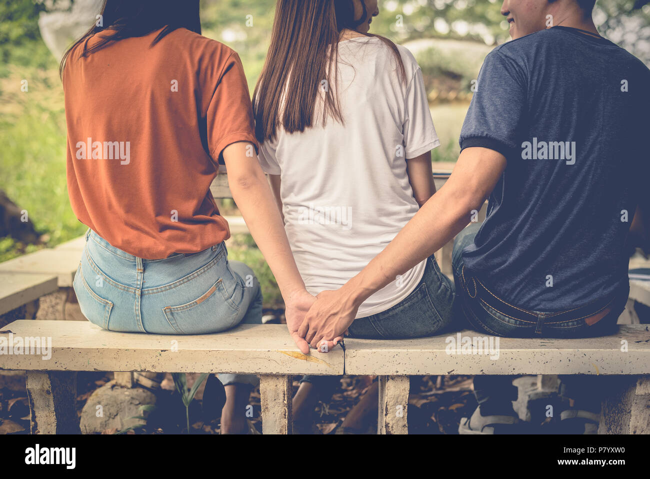 Boyfriend and another woman grab hands from behind together without ...