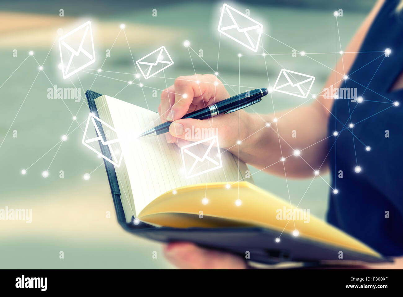 Woman write down letters in notebook for send message without computer ...