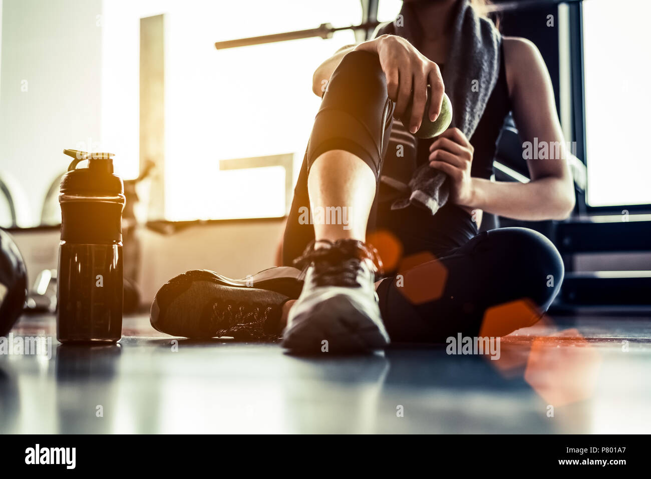 Sport woman sitting and resting after workout or exercise in fitness ...