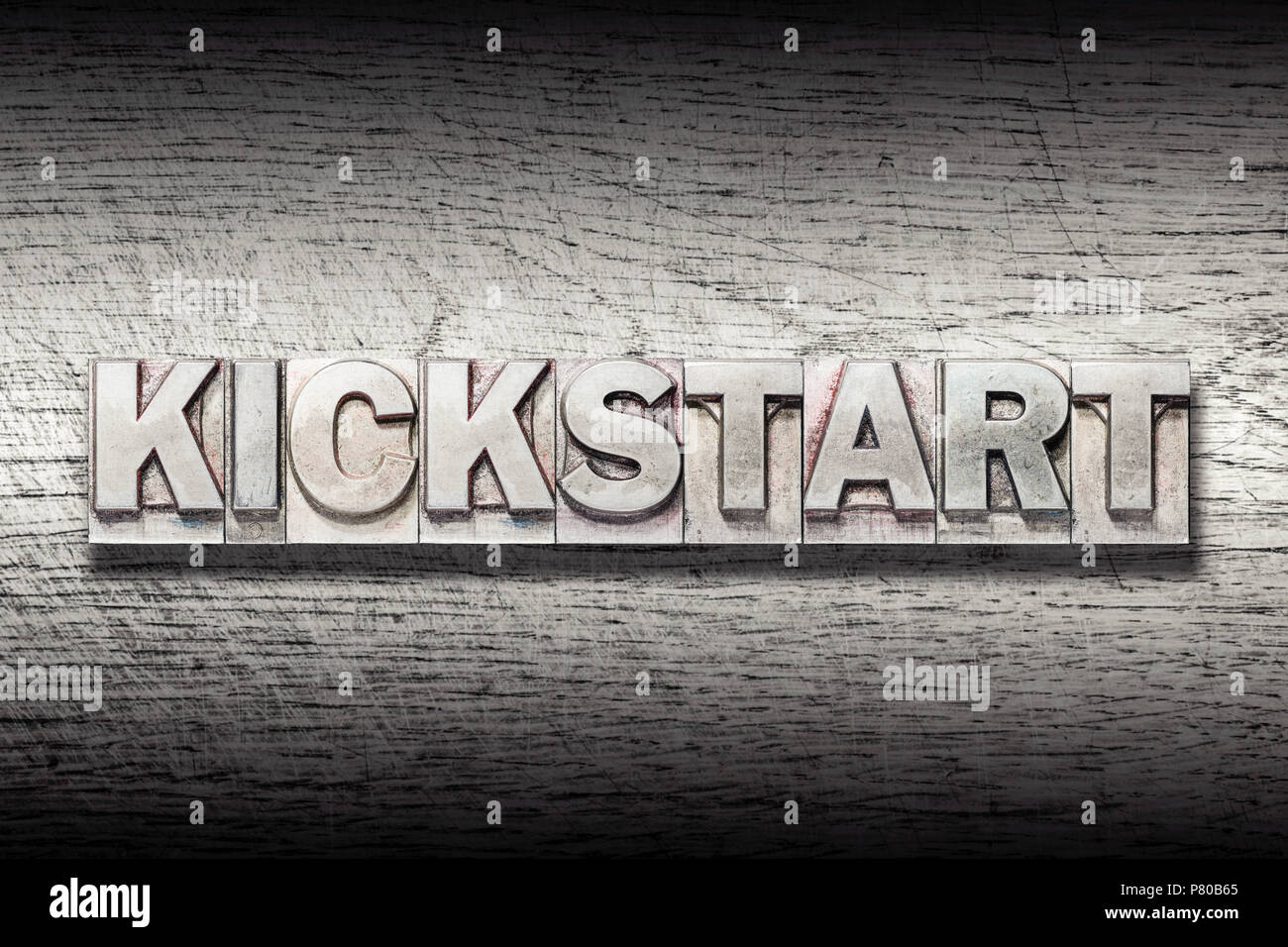 kickstart word made from metallic letterpress on rough wooden texture Stock Photo - Alamy