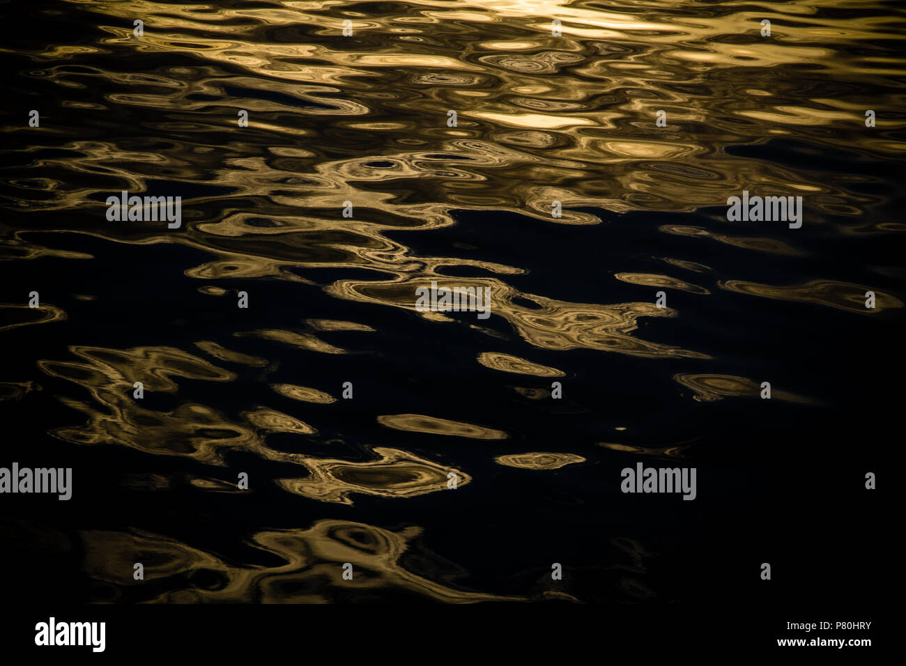 The golden ocean water ripples reflections on sunsets Stock Photo - Alamy
