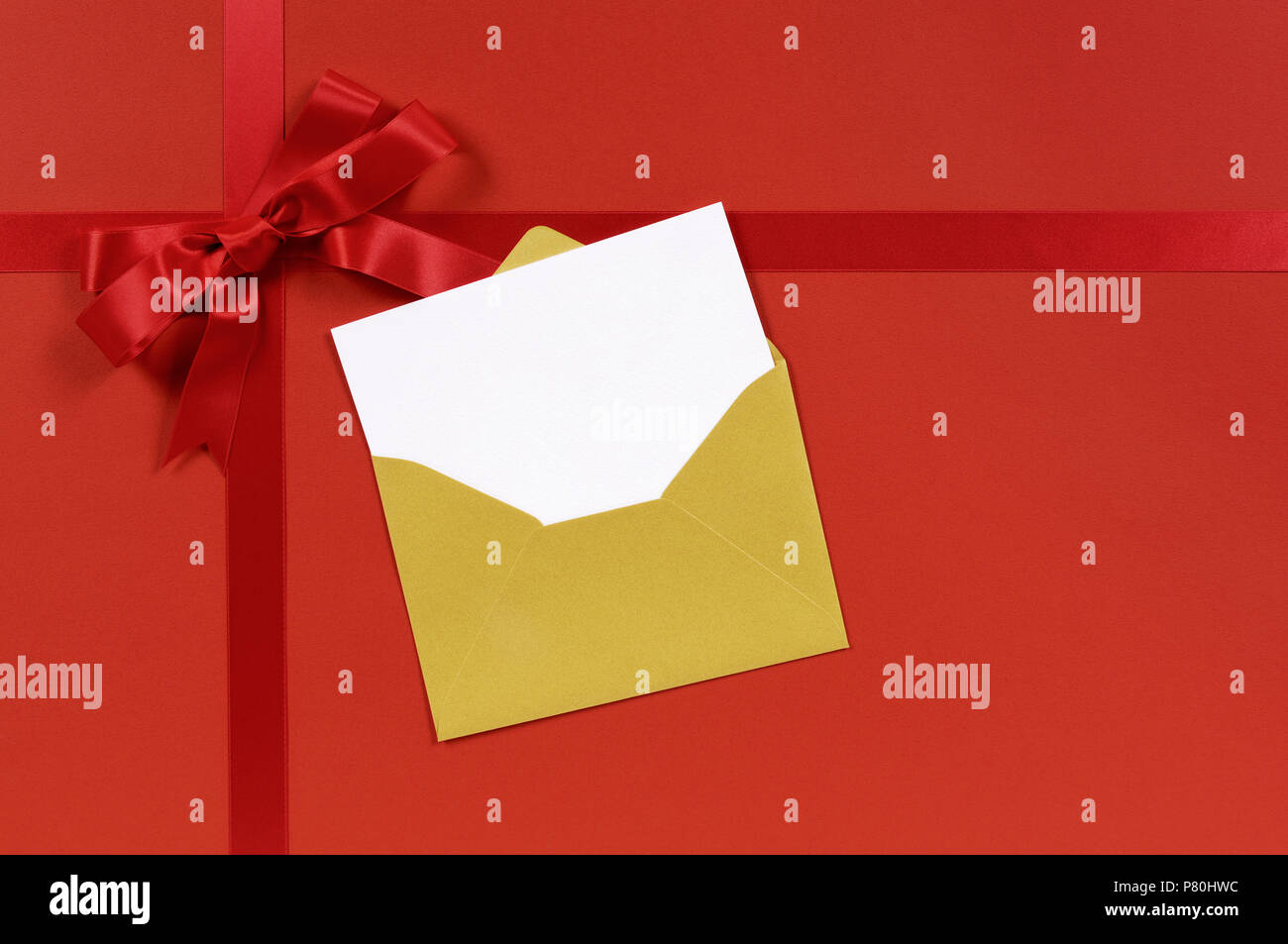 Red gift background with gold envelope and blank invitation or ...