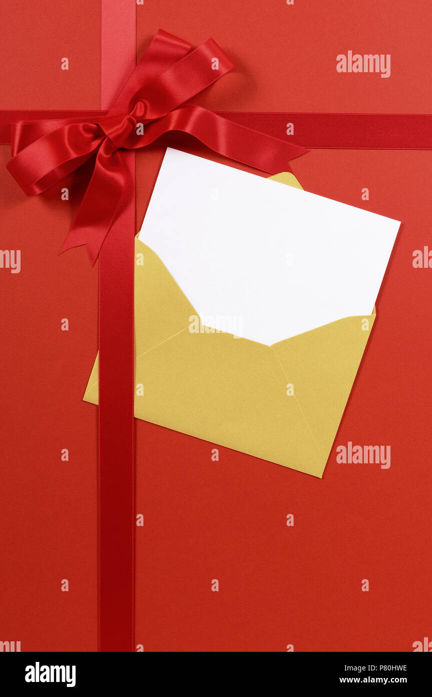 Red gift background with gold envelope and blank invitation or ...