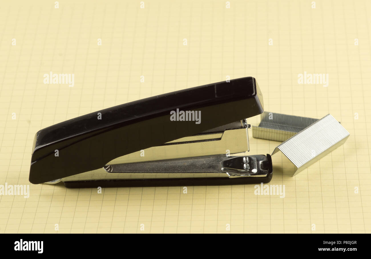 black stapler with paper clips shot close-up Stock Photo - Alamy