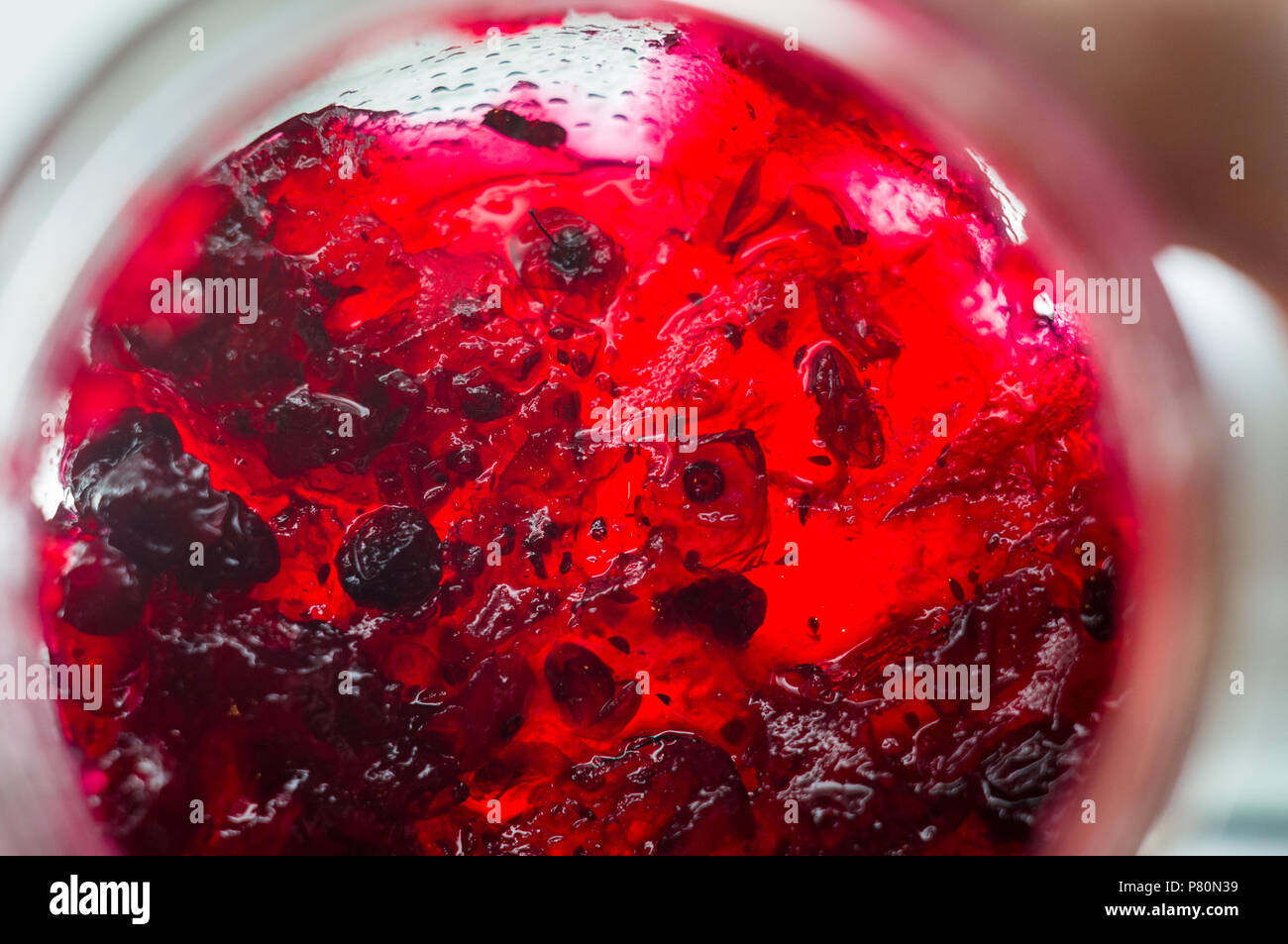 Bright translucent red currant jam in a glass jar, close-up, macro ...