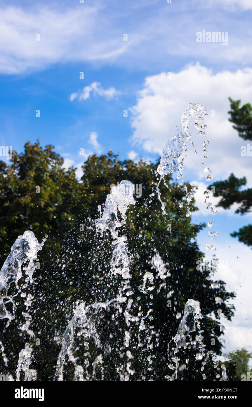 Fountain in city park on hot summer day, beautiful bright streams of ...