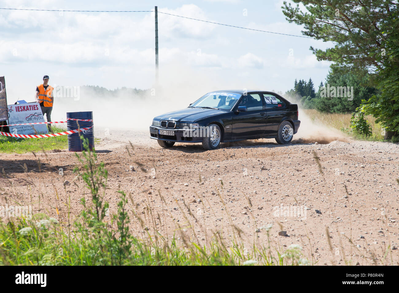 City Livi, Latvia. Amateur rally, dirt road, car with rider. Speed and ...