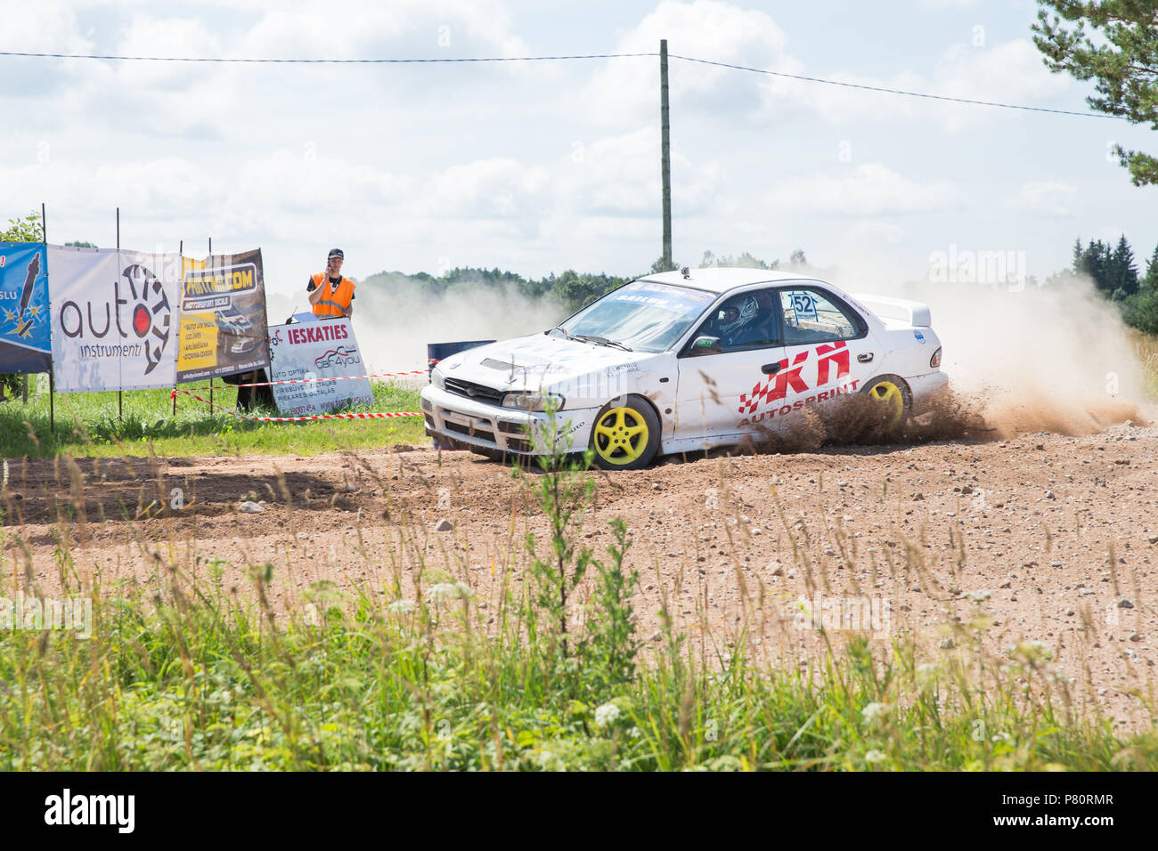 City Livi, Latvia. Amateur rally, dirt road, car with rider. Speed and ...
