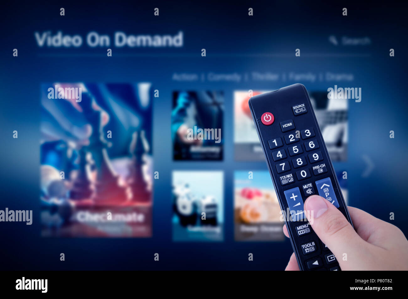 VOD service screen with remote control in hand. Video On Demand ...