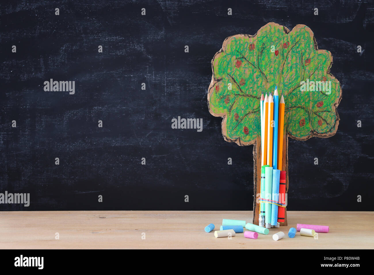 Back to school banner. tree of knowledge and pencils in front of ...
