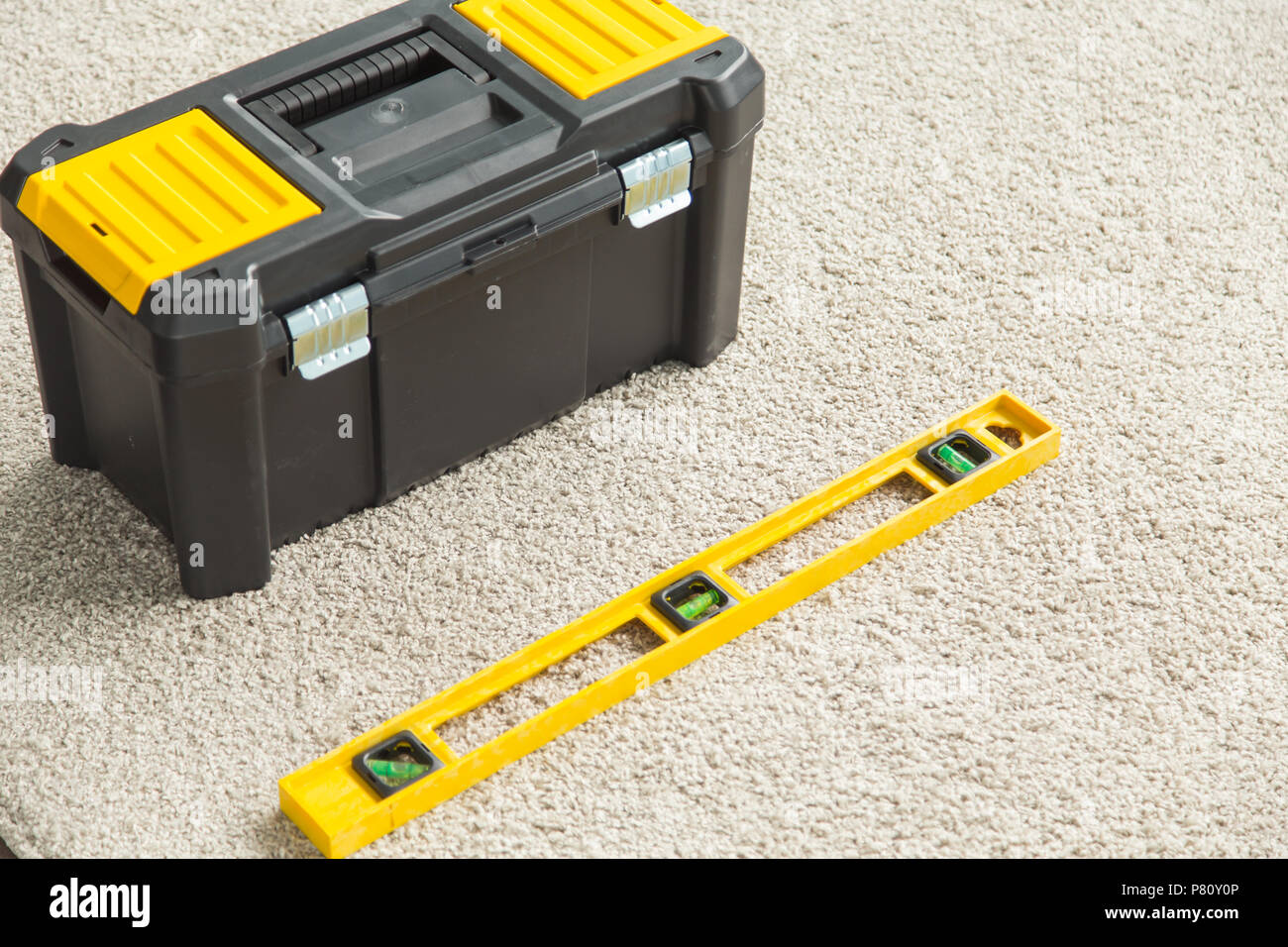 Closeup picture of toolbox and builders level Stock Photo - Alamy