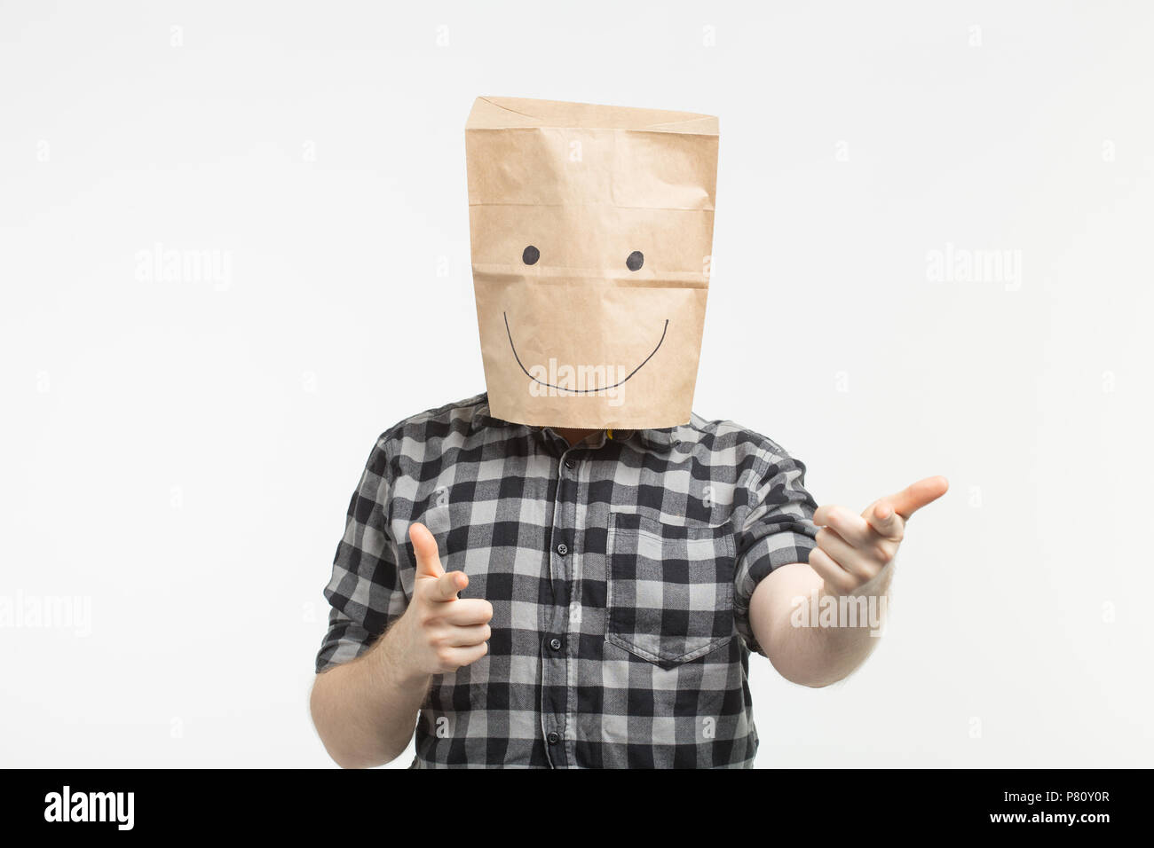 Portrait of man in happy paper bag mask on white background Stock Photo ...