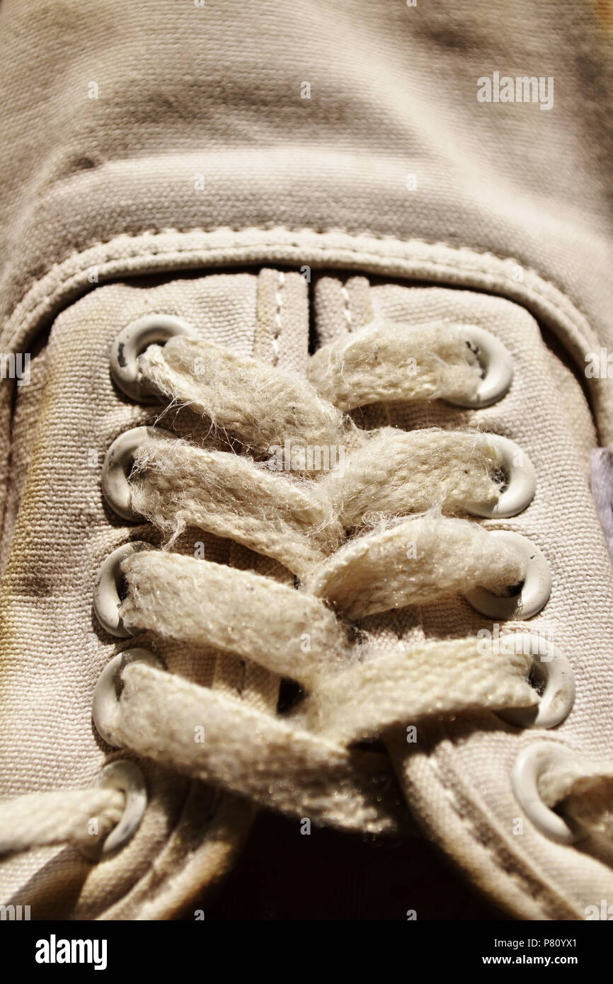 Rope of white sneakers in black background Stock Photo - Alamy