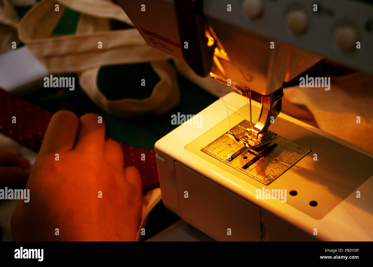 Sewing machine repairs are fabric in industry Stock Photo - Alamy