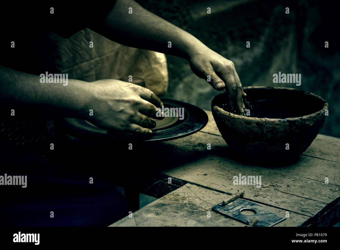 Hands of man working and shaping clay, potter in pottery, craft detail ...