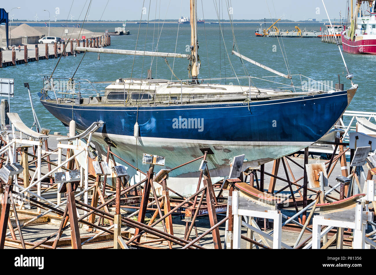 Small yacht put on stilts for repair and maintanance in the harbour of ...