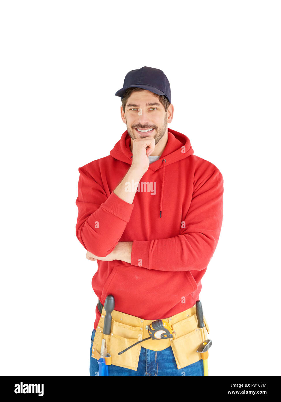 Happy young handyman wearing baseball cap and hoodie while standing at ...