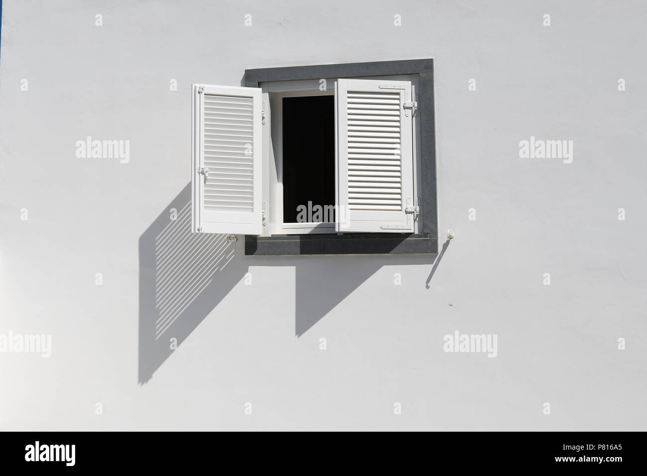 White window shutters on a white building Stock Photo - Alamy