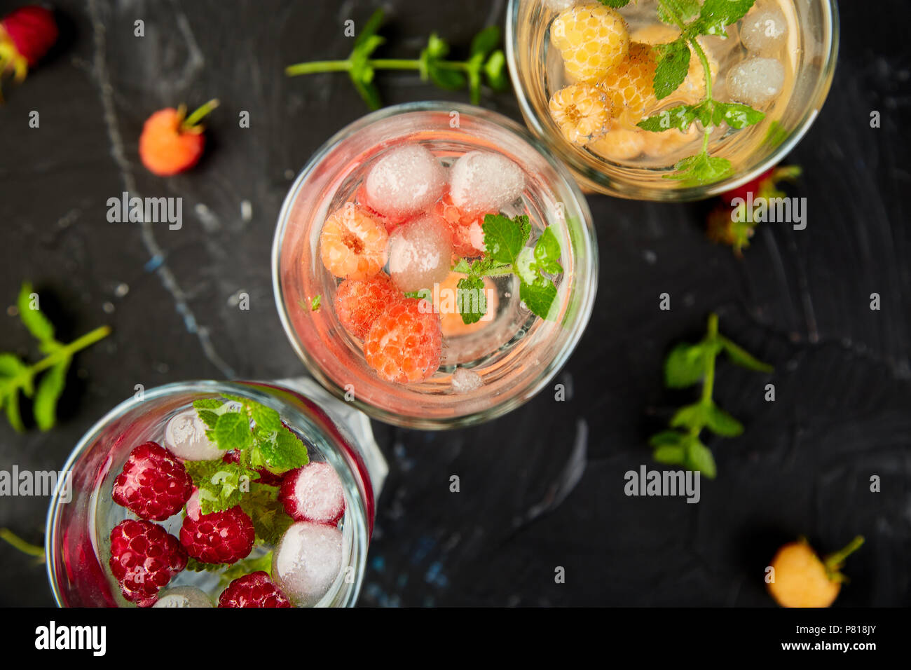 Detox infused flavored water with three color raspberry - red, orange ...