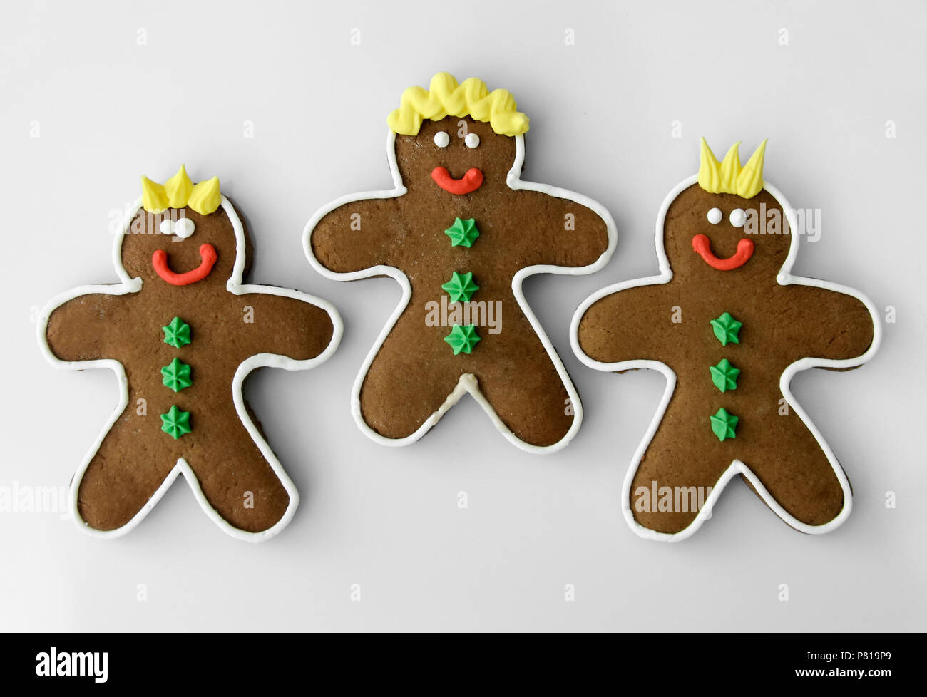 Top view shot, close up of a trio of happy gingerbread men in a row ...