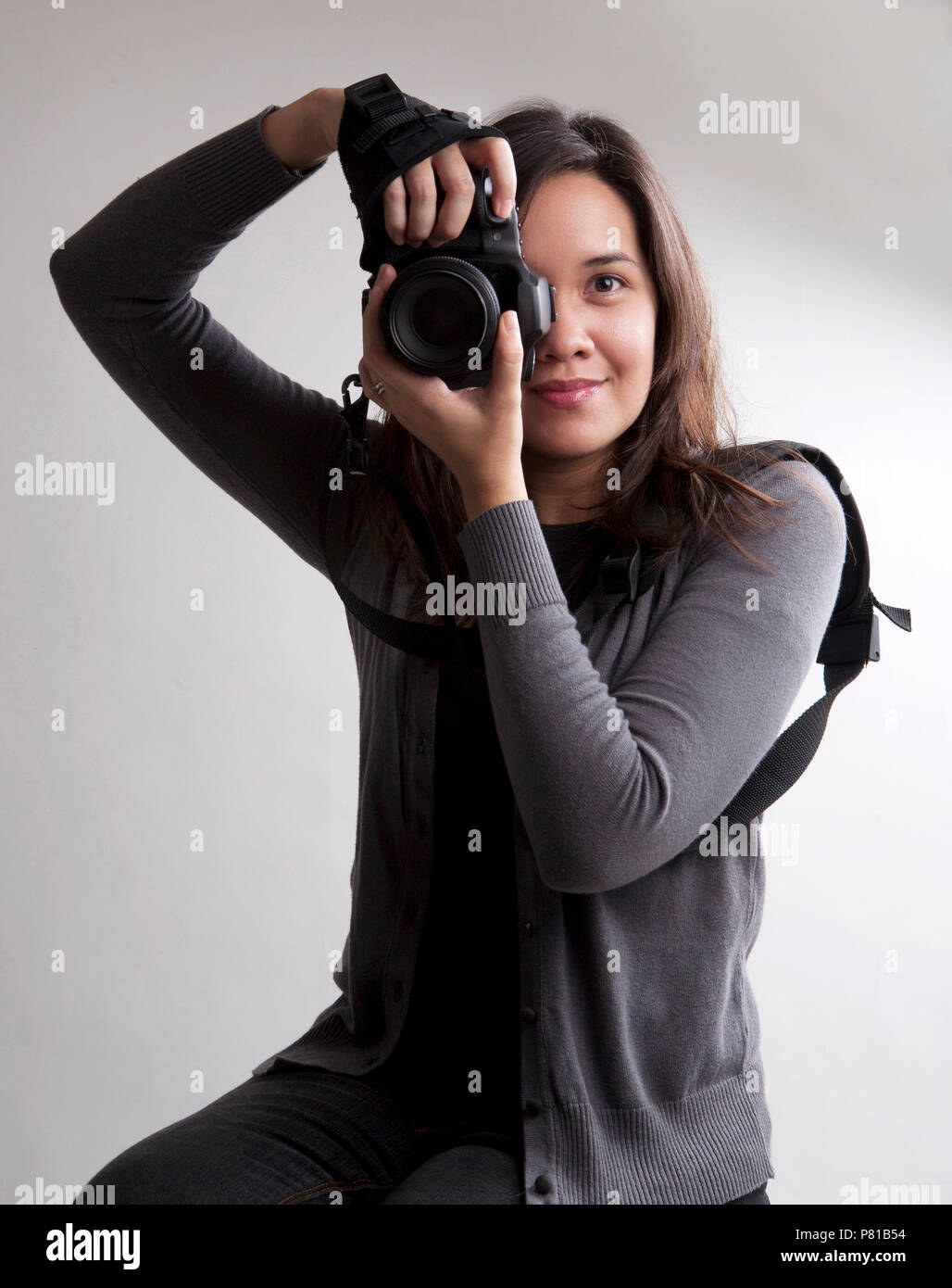 Female photographer posing with a camera Stock Photo - Alamy